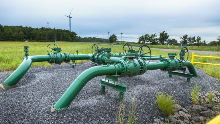 Green Marcellus shale gas pipelines in grass field - Global Contractors